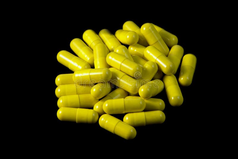 Yellow Pills Isolated on Black Stock Photo - Image of cure, dose: 67558944