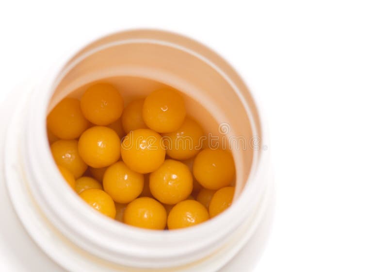 Yellow pills in open box stock image. Image of heap, full - 26315419