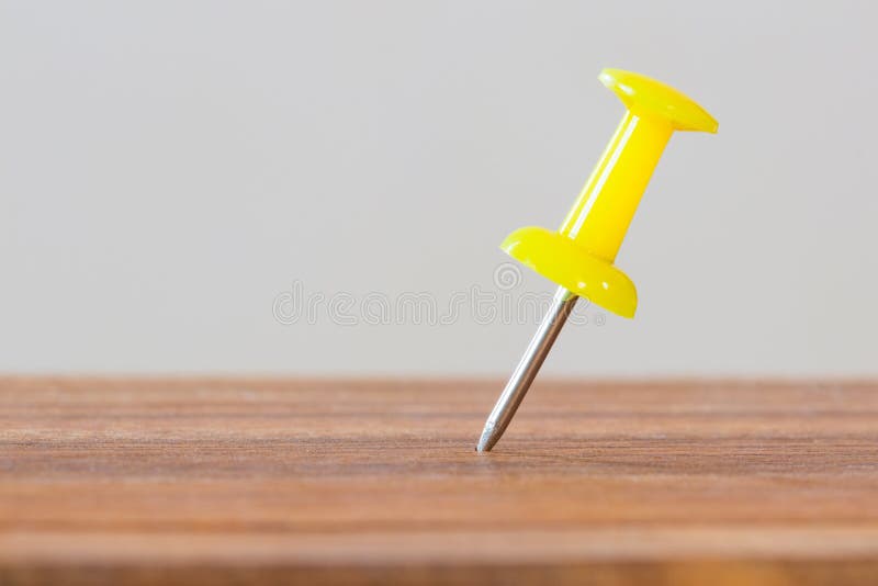 Yellow pin impaled stock image. Image of impaled, wood - 136670263