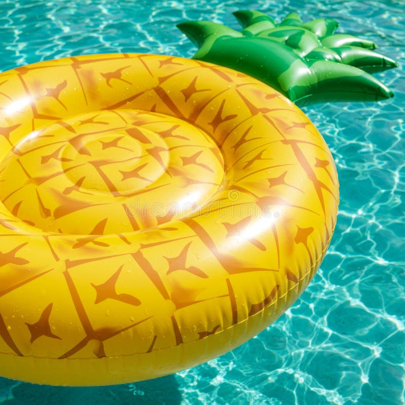 Yellow Pineapple Inflatable Pool Float in Blue Water Stock Image ...