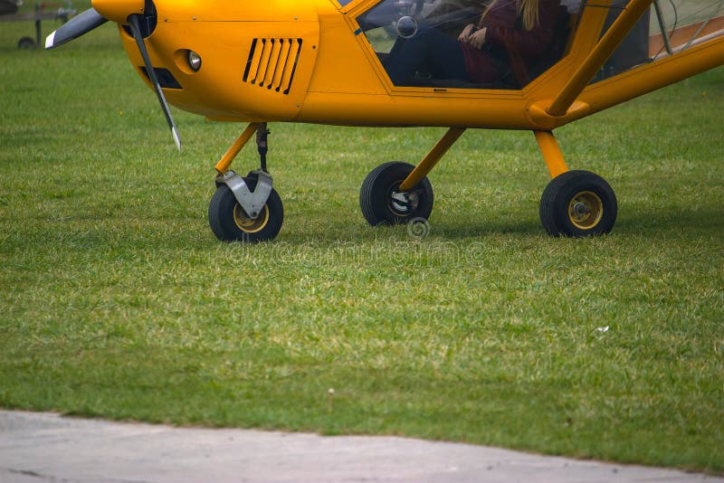 Yellow Plane on a Green Field Stock Image - Image of light, flight ...