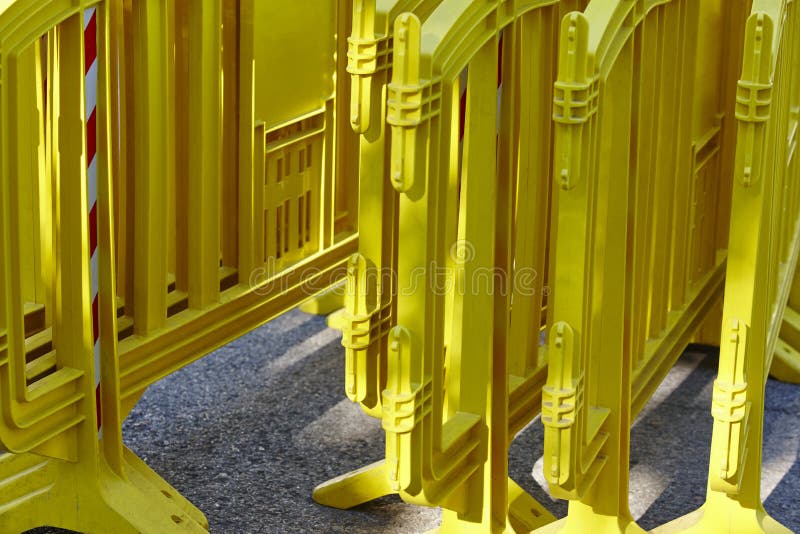 Yellow Plastic Barrier Fence Over an Asphalt Road Stock Photo - Image ...