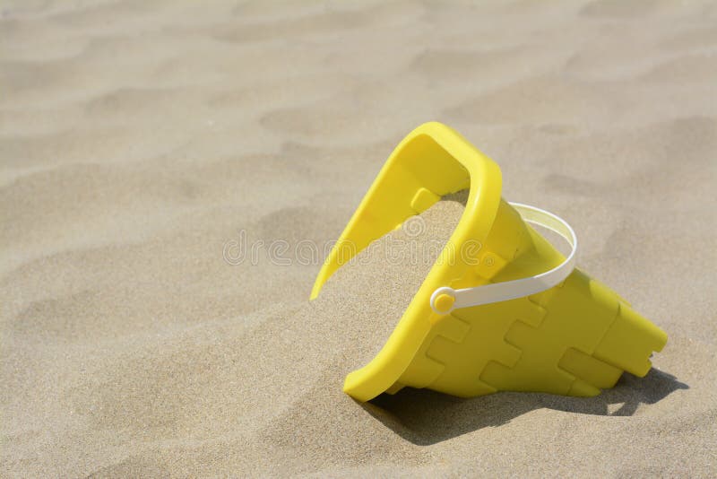 Yellow Plastic Bucket on Sand, Space for Text. Beach Toy Stock Photo ...