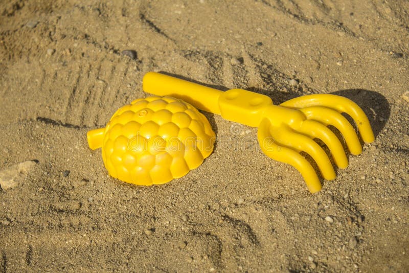 Yellow Plastic Children`s Beach Toys on Sand Stock Image - Image of ...