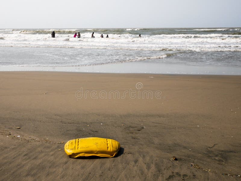 Yellow Plastic Container on a Caribean Beach while People Having Fun ...