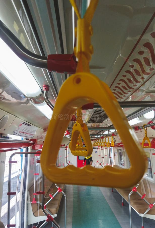 A Yellow Plastic Handle on a Commuter Train Stock Photo - Image of line ...