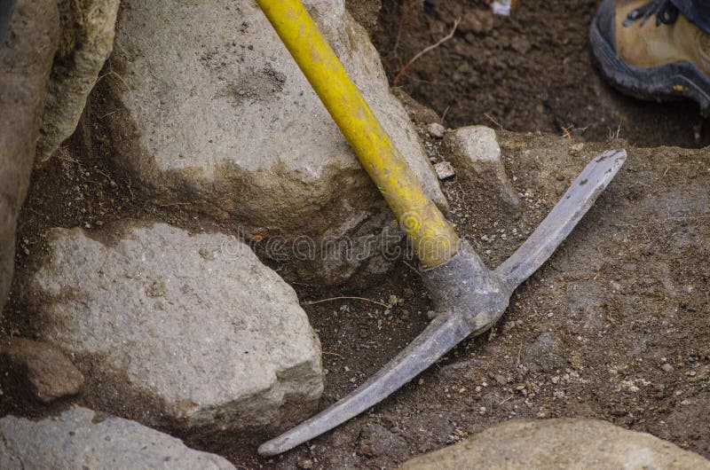 A Plastic-handled Pick Leaning Against a Wall during Work at an ...