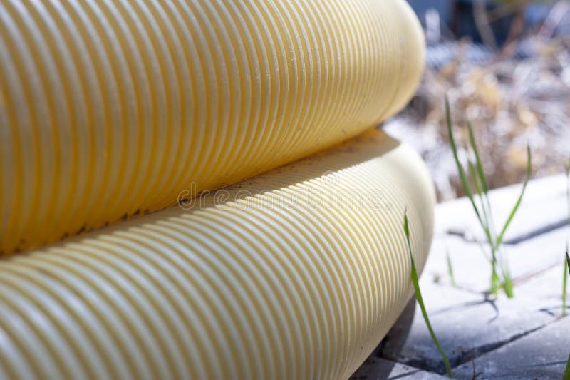 Yellow plastic pipe. stock image. Image of construction - 231166517