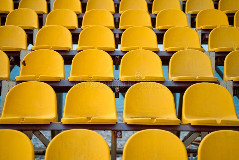 Yellow Plastic Seats on the Podium of a Small Sports Field Stock Image ...
