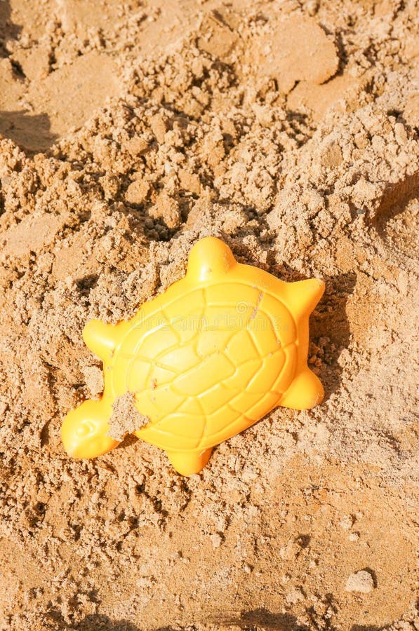 Yellow Plastic Toy Sand Form in Turtle Shape on the Sand on a Sunny Day ...