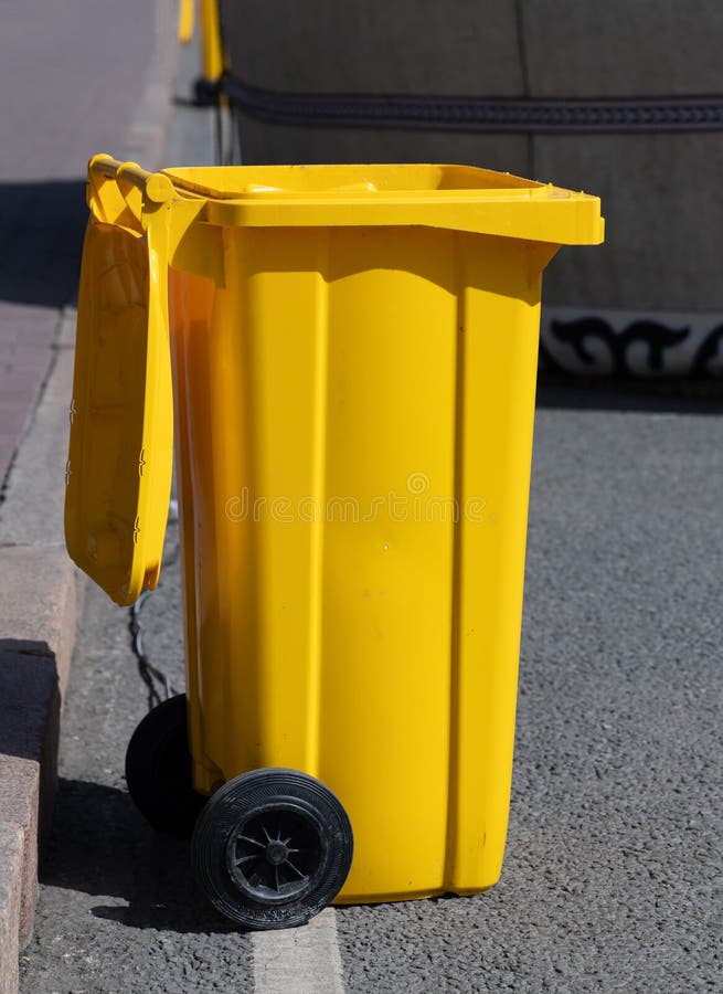 Yellow Plastic Trash Can on Wheels Stock Photo - Image of urban, wheels ...
