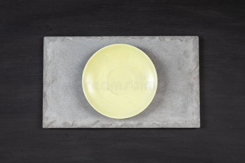 Yellow Plate on Concrete Plate on Dark Background Stock Photo - Image ...