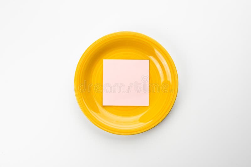 Yellow Plate with a Sheet of Paper Stock Photo - Image of fragile ...