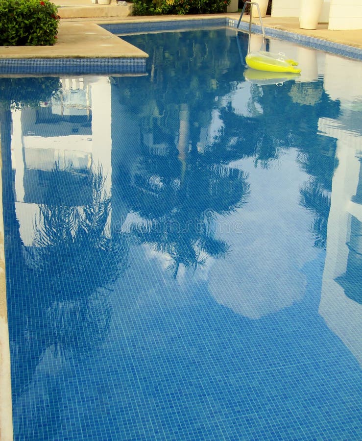 Yellow Pool Float and Reflections of Palm Trees on Water Surface of ...