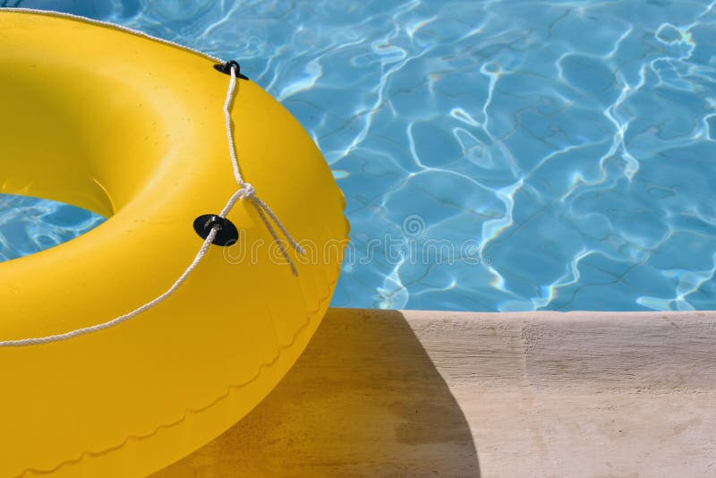 Yellow Pool Float, Ring Floating in a Refreshing Blue Swimming Pool ...