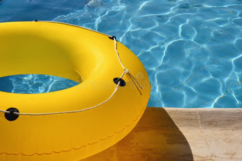 Yellow Pool Float, Ring Floating in a Refreshing Blue Swimming Pool ...