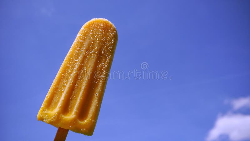 Yellow popcicle blue sky stock image. Image of food, delissious - 92562009