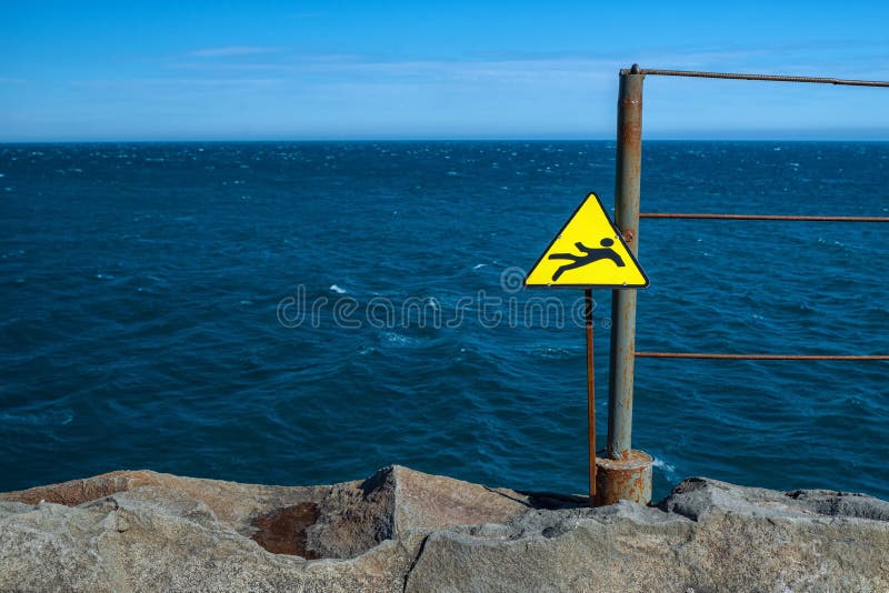 A Yellow Possible Fall Sign on a Cliff Stock Image - Image of ...