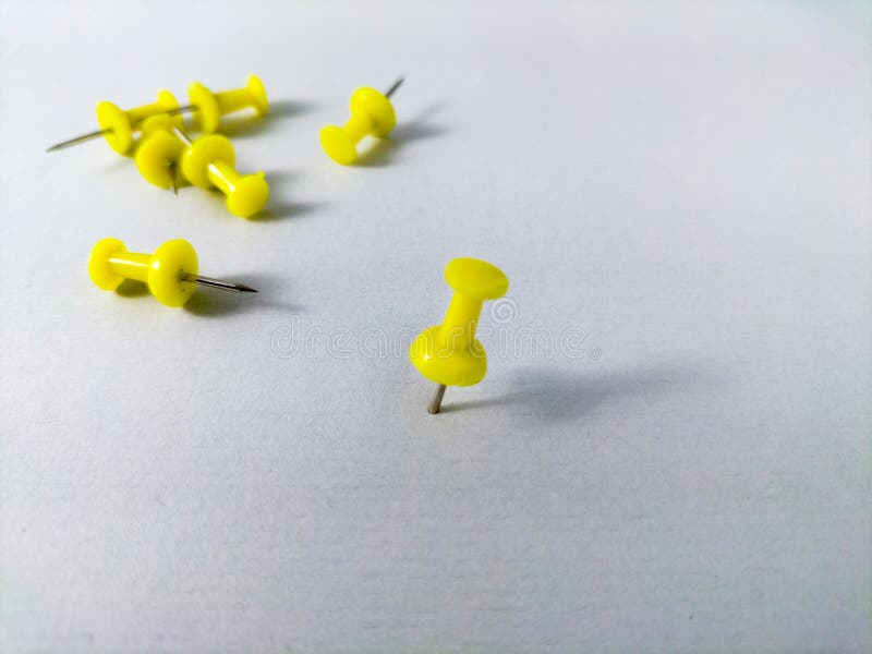 Yellow push pins on white stock image. Image of undefined - 377095725