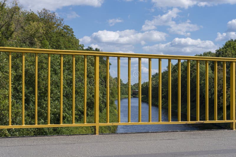 Yellow railing on a bridge stock image. Image of railing - 157781581