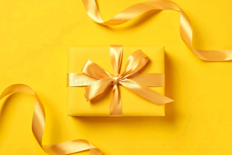Yellow Rectangular Box with a Gift Wrapped in Yellow Paper and Tied ...