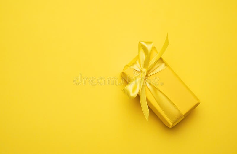 Rectangular Box with a Gift Wrapped in Yellow Paper and Tied with a ...