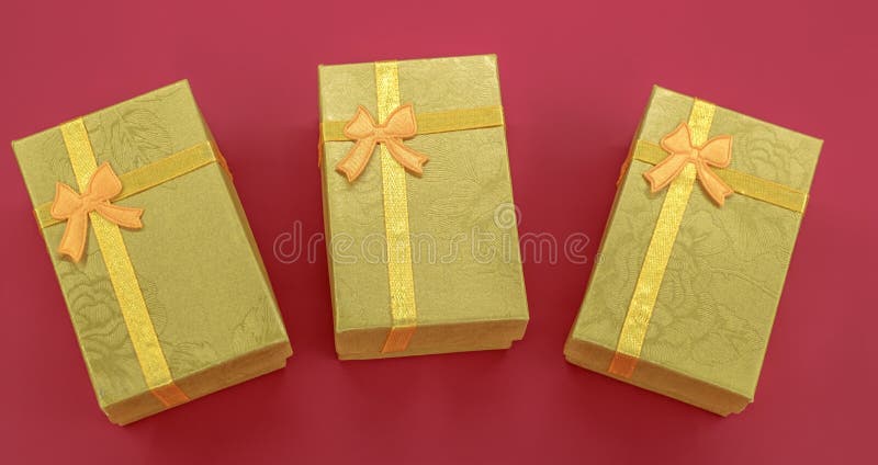 Rectangular Box with a Gift Wrapped in Yellow Paper and Tied with a ...