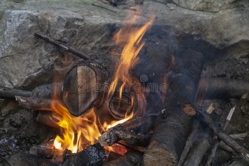Yellow Red Camp Fire in the Woods with Big Rock Stock Image - Image of ...