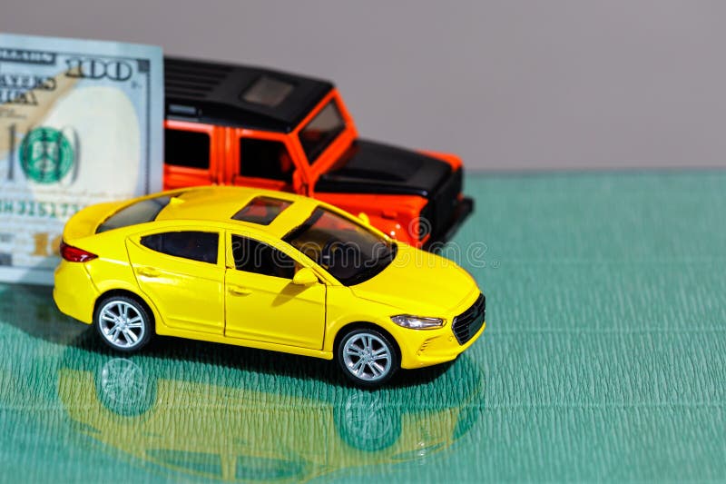 Yellow and Red Car Separated by a Hundred Dollar Bill Stock Image ...