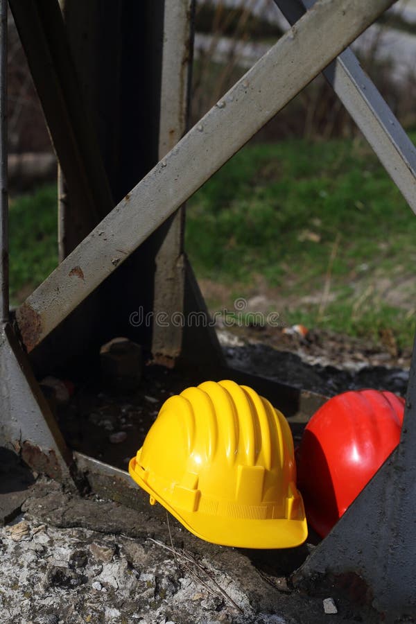 Yellow and Red Helmets on a Work Site Stock Photo - Image of head ...