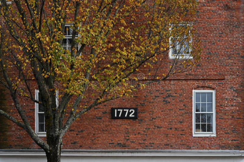 Yellow and Red Leaves on Fall Tree with Red Brick Facade Stock Photo ...