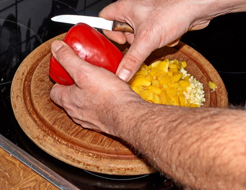 Yellow and Red Peppers Capsicum Cut with a Knife on a Board Stock Photo ...