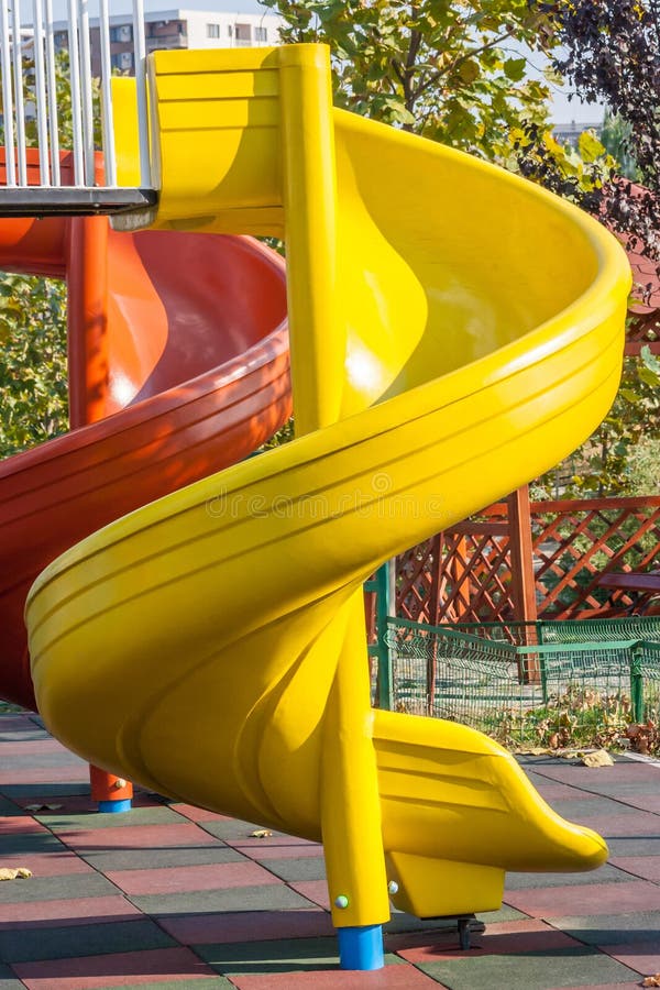 Yellow and Red Round Slides in Bright Sunlight Stock Image - Image of ...