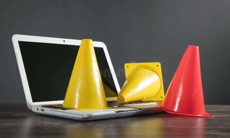 Yellow and Red Traffic Cones on Laptop Keyboard Stock Image - Image of ...