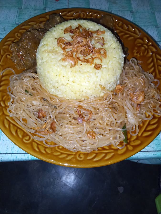 Yellow Rice on the Brown Plate with Fried Garlic and Beef Steak Stock ...