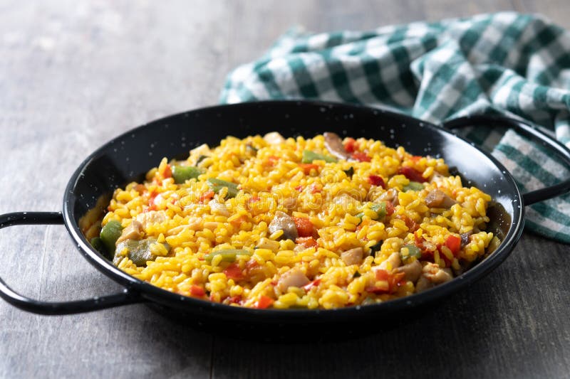 Yellow Rice with Chicken and Vegetables on Wood Stock Photo - Image of ...