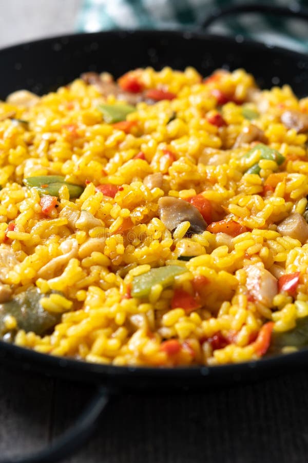 Yellow Rice with Chicken and Vegetables on Wooden Table Stock Image ...