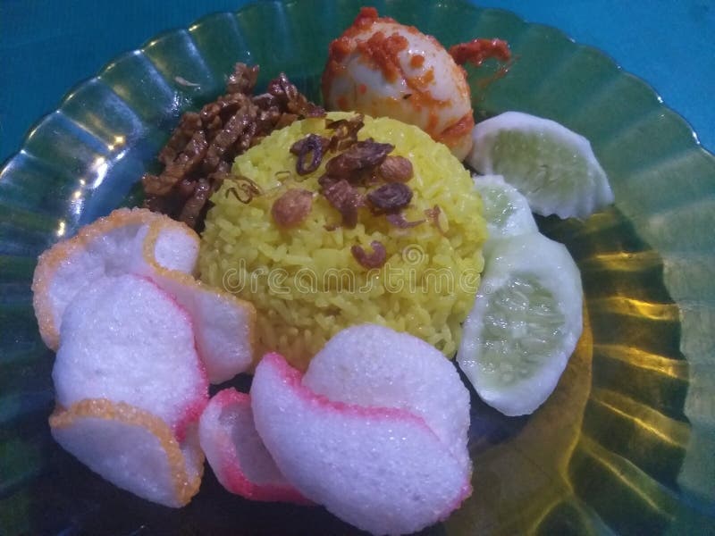 Yellow Rice with Cucumber and Tempeh Orek and Cracker Stock Image ...
