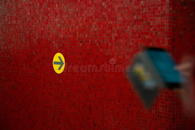 Yellow Right Arrow on a Red Wall Stock Photo - Image of poster, symbol ...