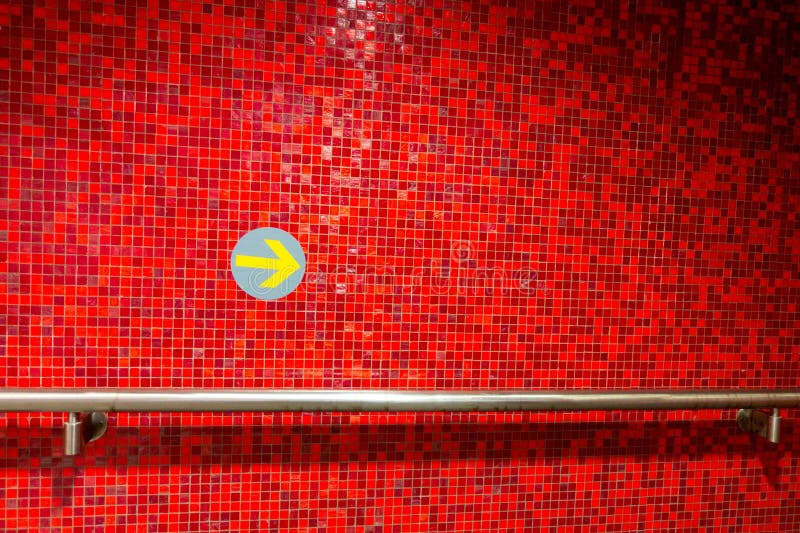 Yellow Right Arrow on a Red Wall on a Subway Stock Image - Image of ...