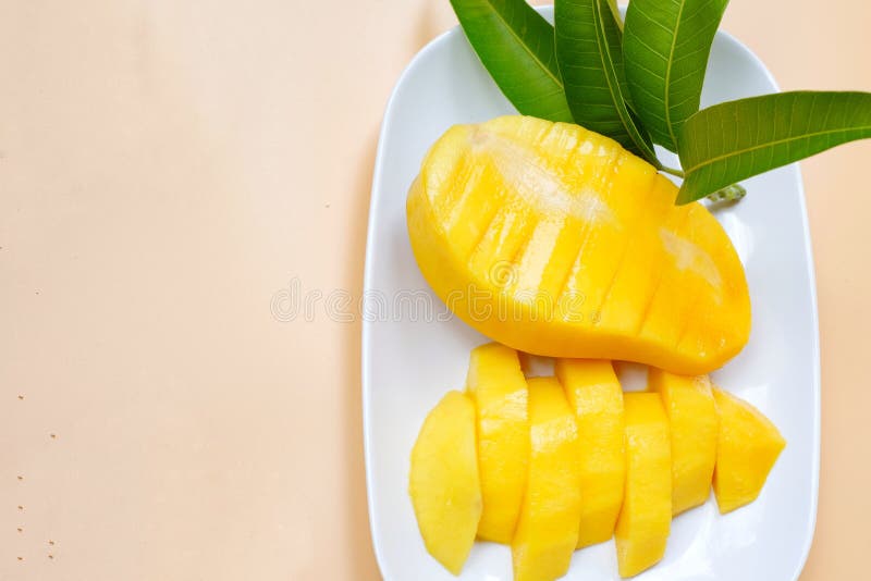 Two Mangoes and Pieces of Cubes with Green Leaves Isolated on White ...