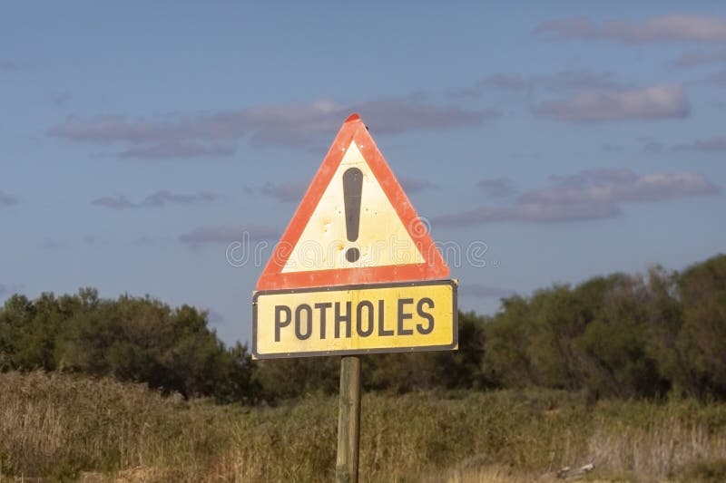 Yellow Road Traffic Warning Sign for Potholes at the Side of a Rural ...