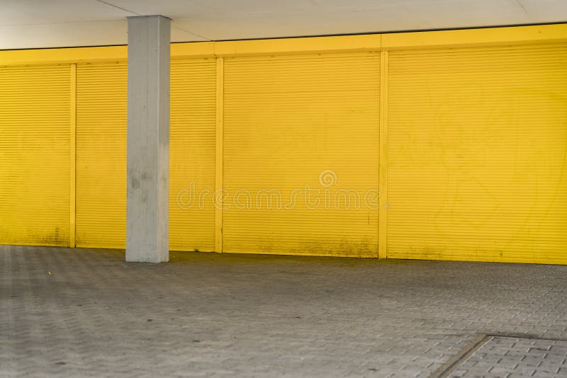 Yellow Roller Shutter and Pavement for Backgrounds Stock Image - Image ...
