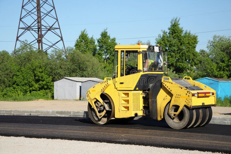 Yellow Rolling Machinery Paving a Road Editorial Stock Photo - Image of ...