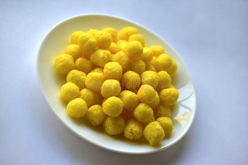 Yellow Round Corn Snacks on a White Plate Stock Image - Image of ...