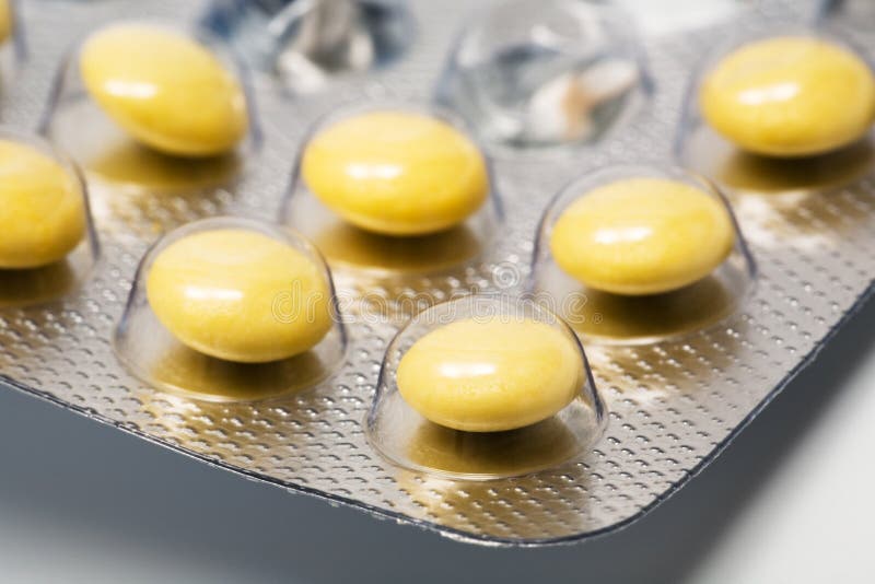 Yellow and round pills stock image. Image of medicate - 10877149