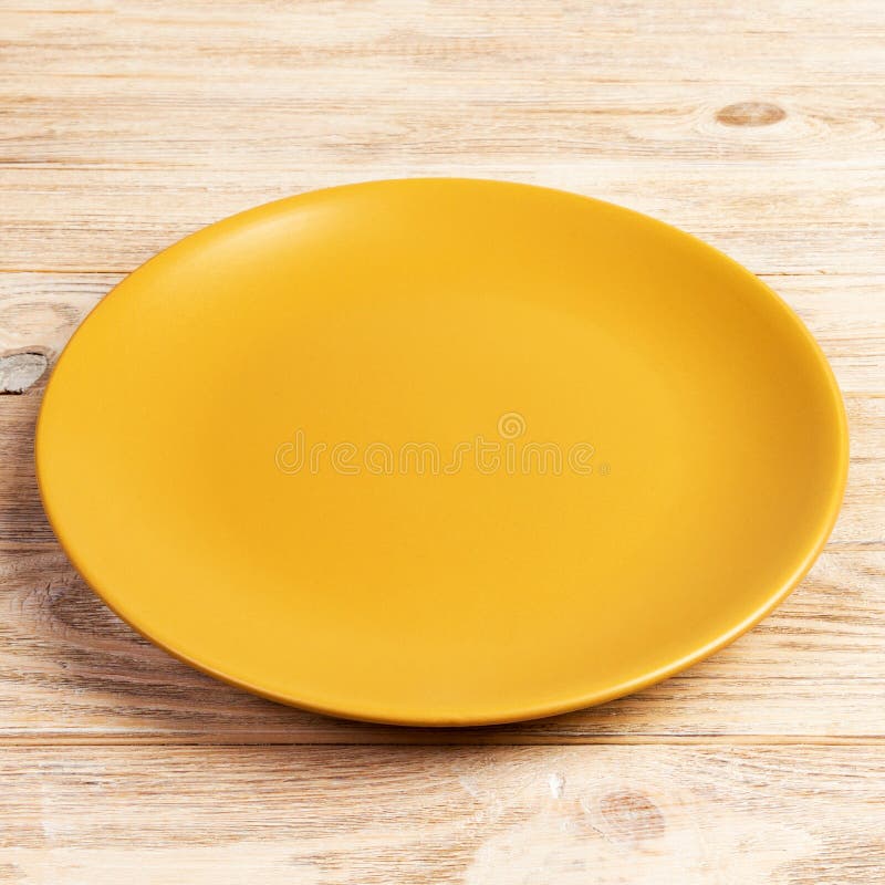 Yellow Round Plate on Wooden Table Background. Top View, Template for ...