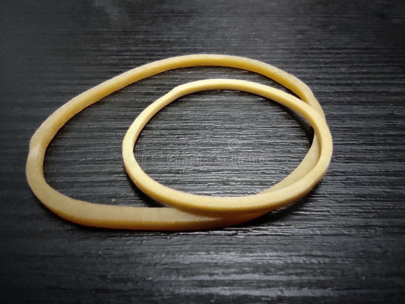 Yellow Rubber Band on Top of Dining Table Stock Image - Image of circle ...