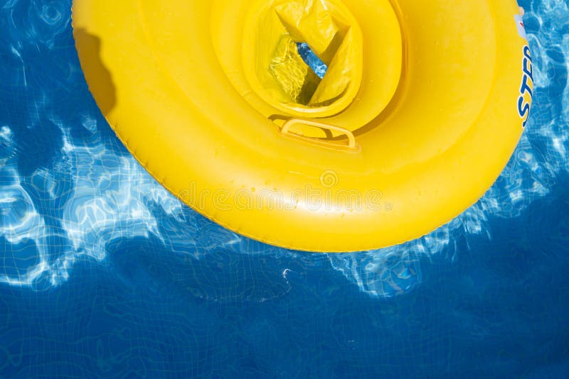 Yellow Rubber Ring Floating in a Pool. Stock Image - Image of sunny ...