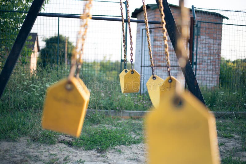 Yellow Rubber Swing on Chains in the Backyard Stock Image - Image of ...
